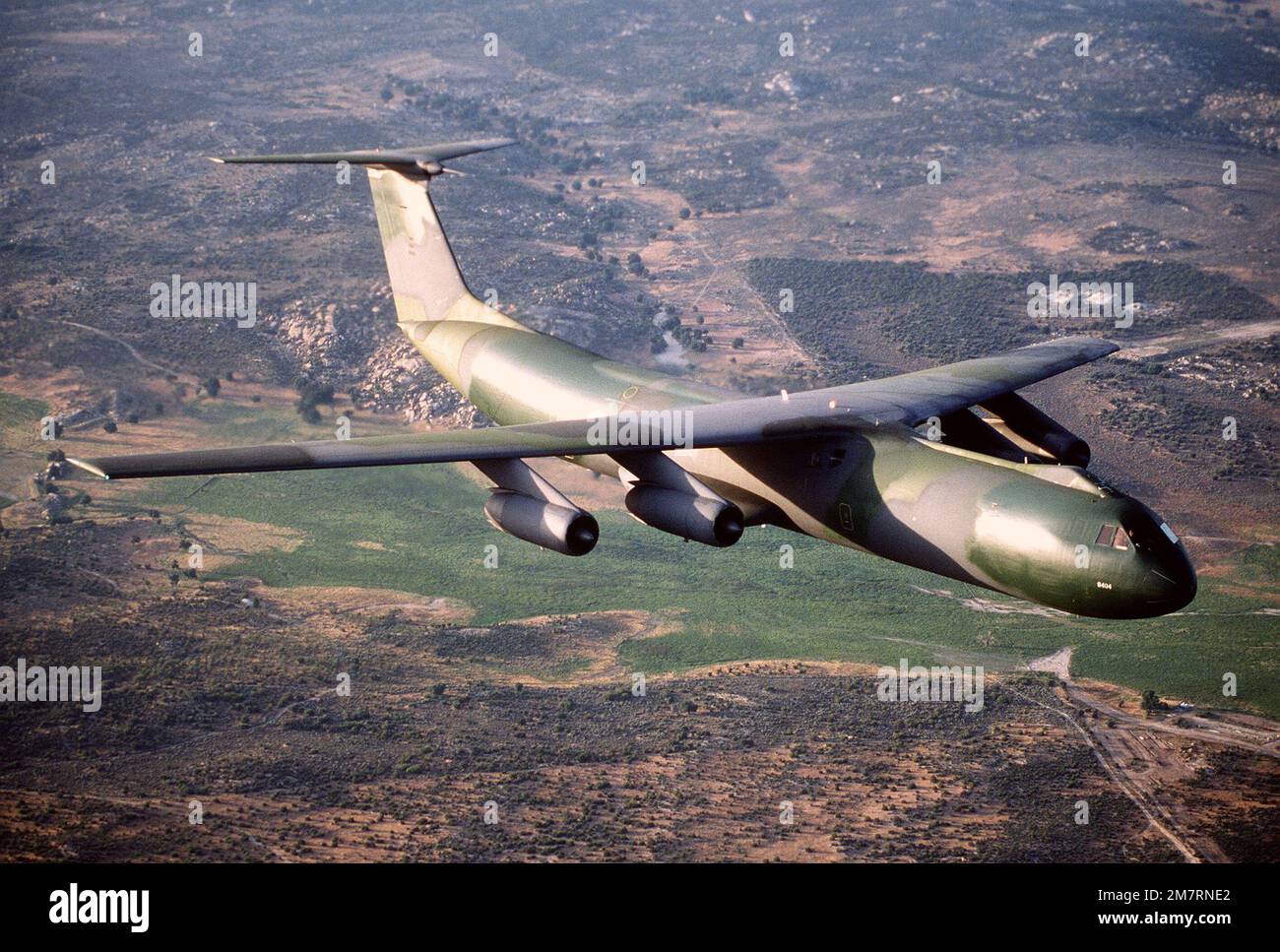 AN air-to-air left front view of a C-141B Starlifter aircraft with the ...