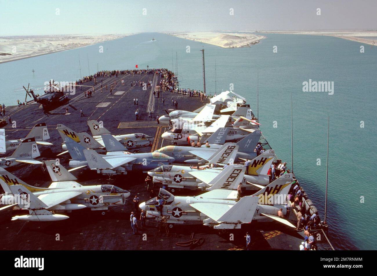 An overhead view of aircraft and crewmen on the forward flight deck of ...