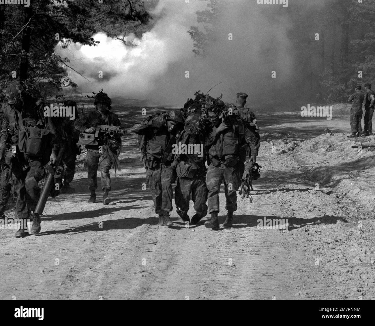 A member of the Enlisted Instructor Company is aided by fellow Marines ...