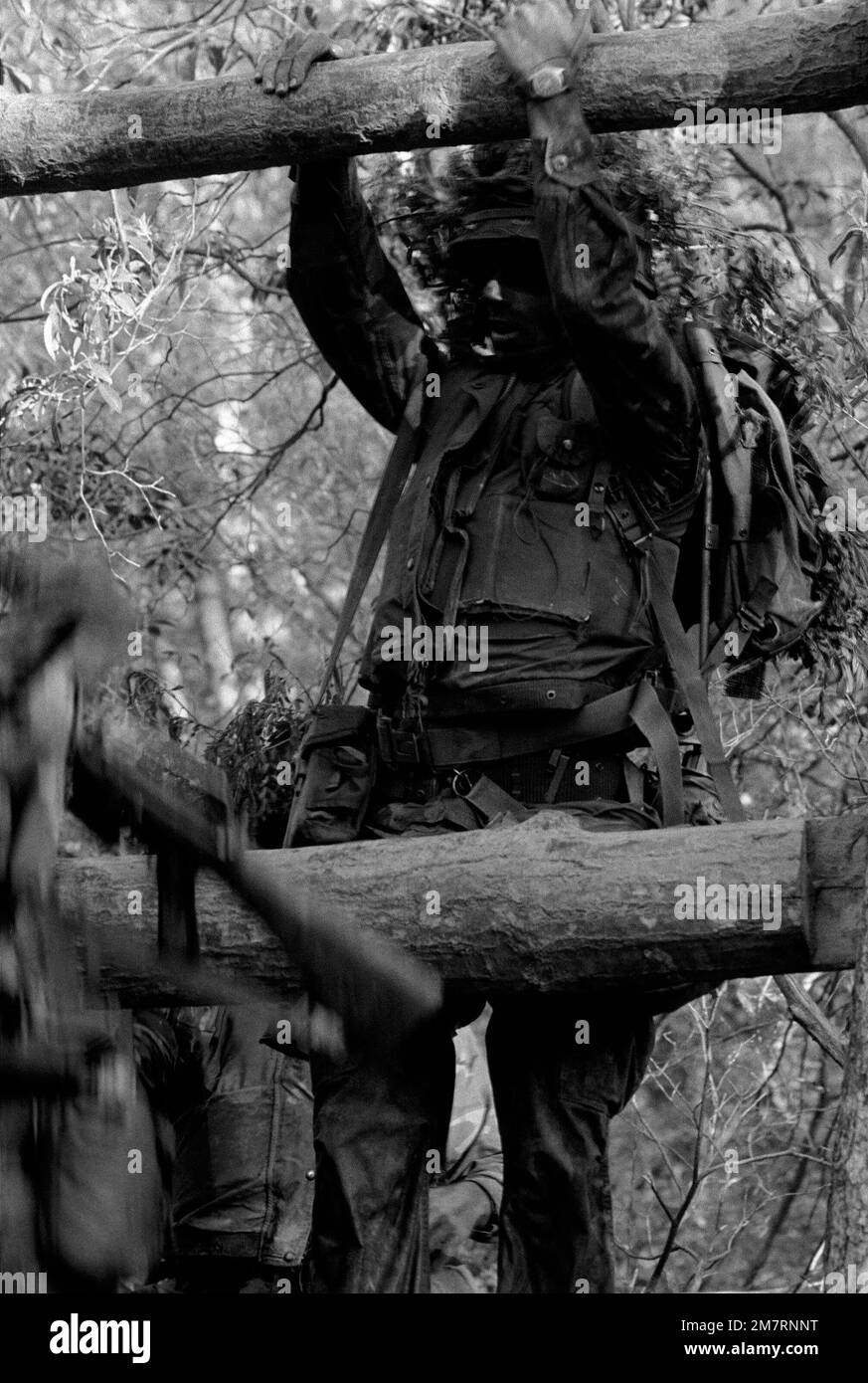 A Marine makes his way over an obstacle during the 1981 Super Squad ...