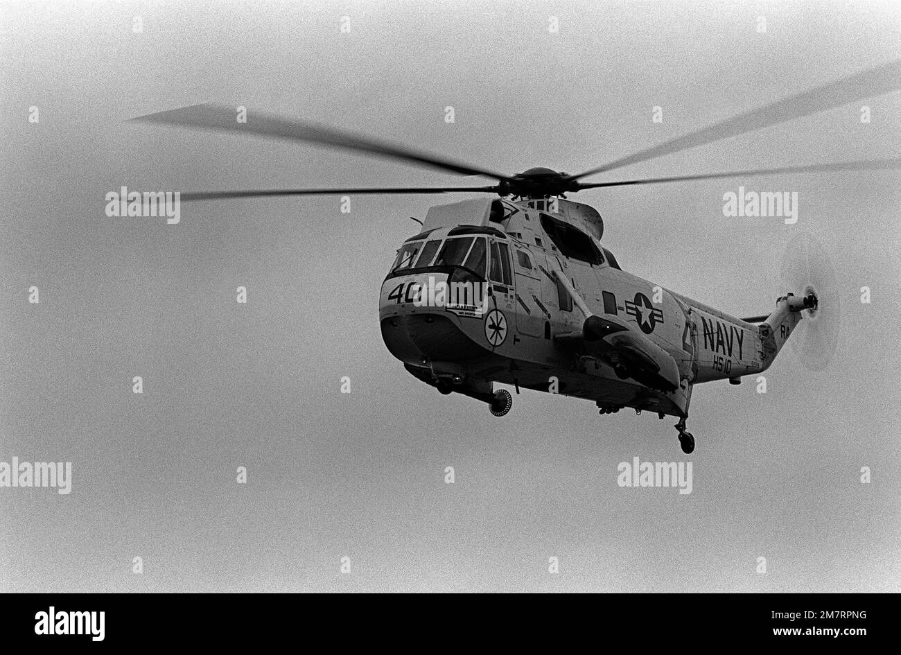 An underside view of an SH-3D Sea King helicopter hovering above the ...