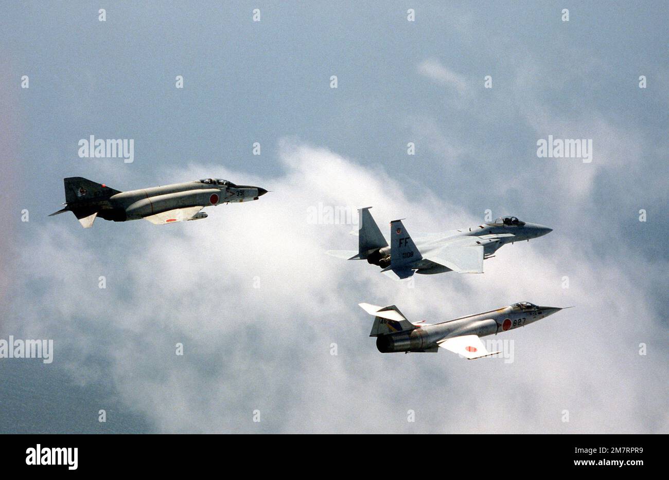 An air-to-air right side view of an F-15 Eagle (middle), a Japanese Air ...