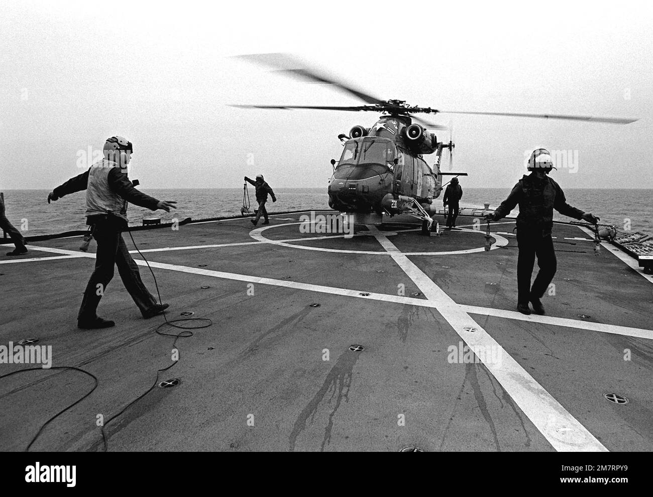 Flight deck crewmen aboard the destroyer USS JOHN HANCOCK (DD-981 ...