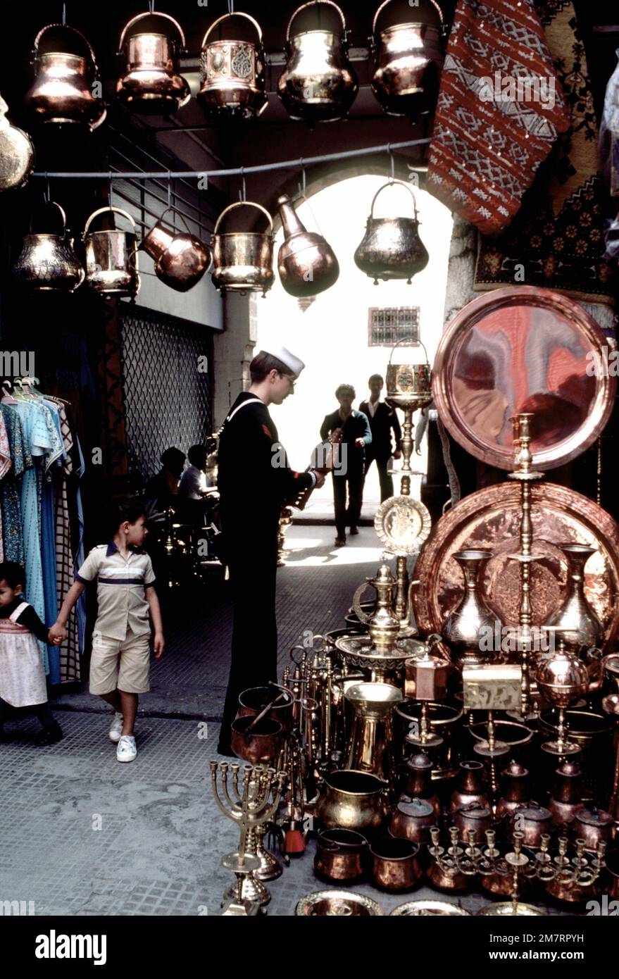 Fireman Don Bailey looks at merchandise in a copper shop during a visit ...