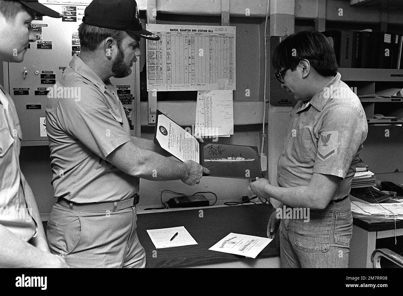 A certificate of re-enlistment is presented to a newly re-enlisted ...