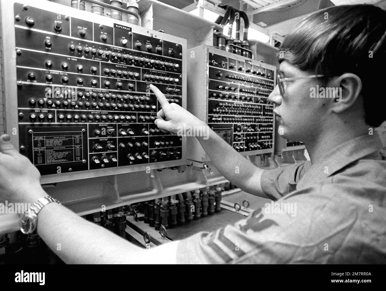 Data Systems Technician 3rd Class Tim Russell operates a sophisticated ...