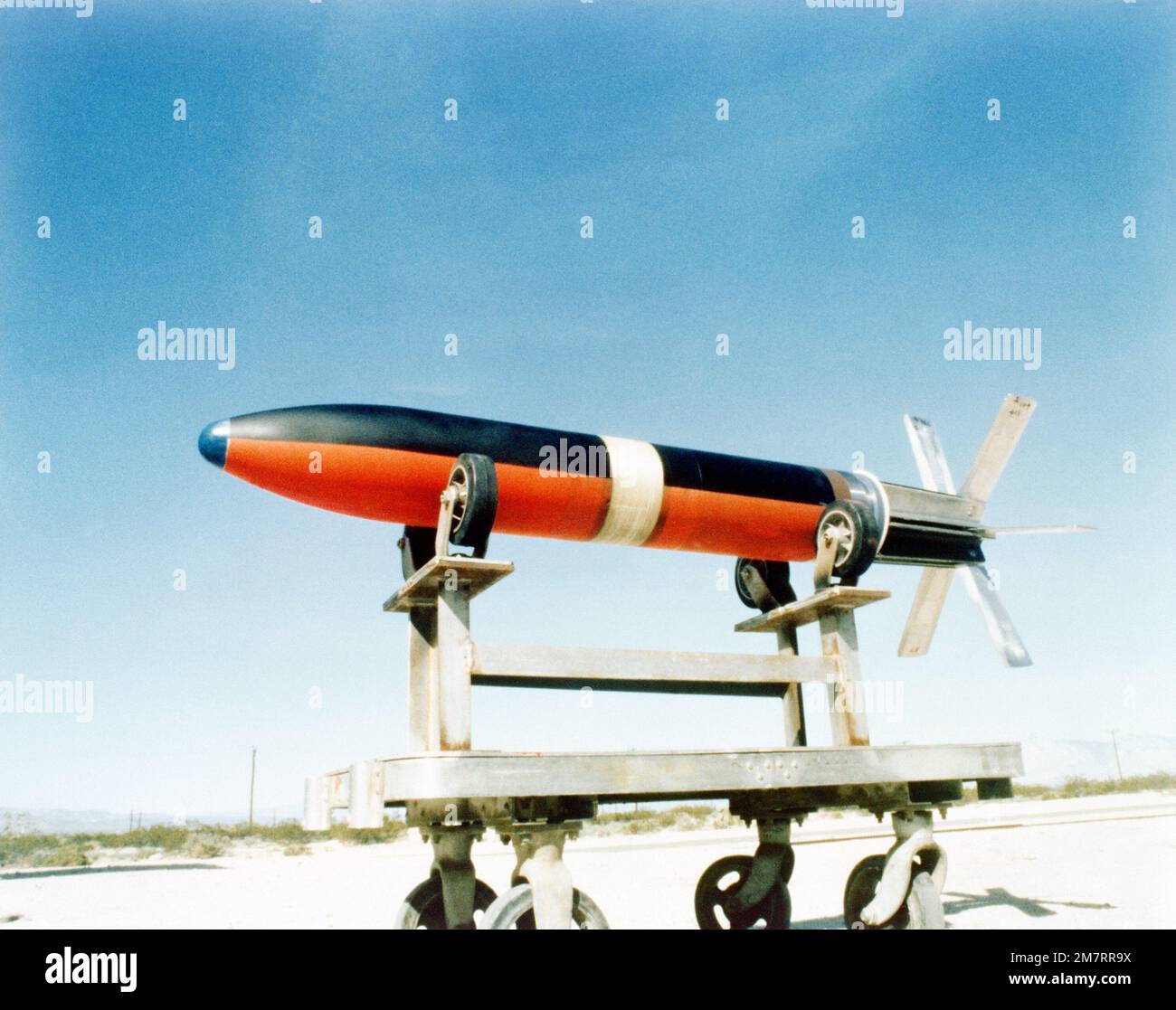 A left side view of an 8-inch projectile assembled with fins open ...