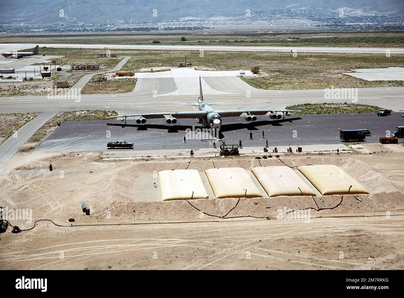 An aerial view of a hot-bladder pit refueling site and a parked B-52H ...