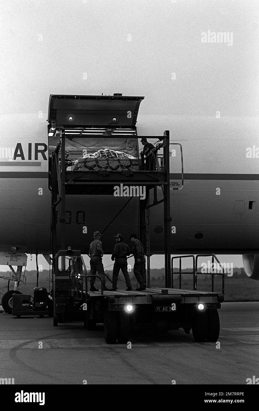 Crewmen off-load seats from a KC-10 Extender aircraft onto a Cochran ...