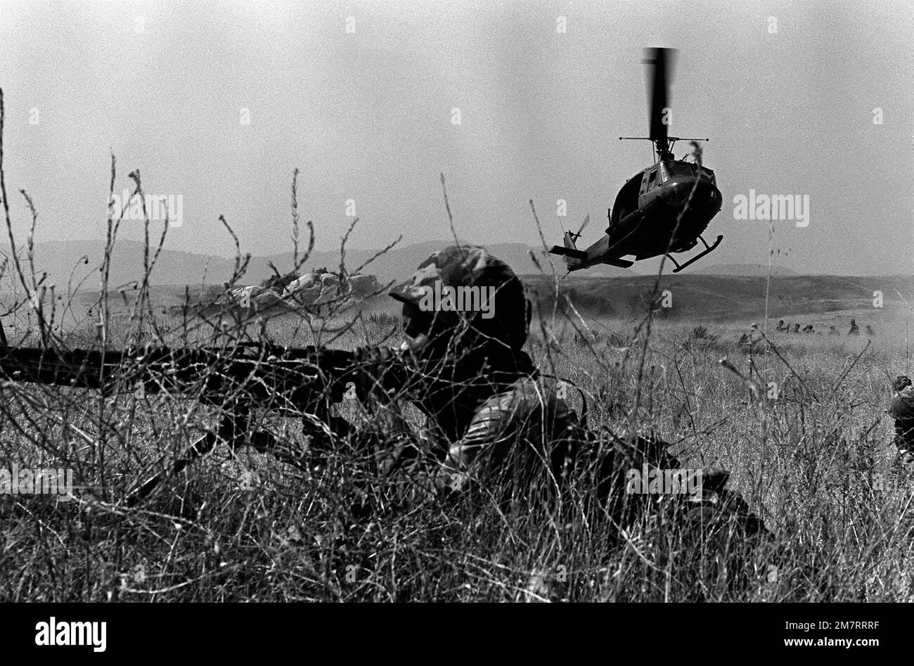 A Marine infantryman provides a field of covering fire with his M-60 ...