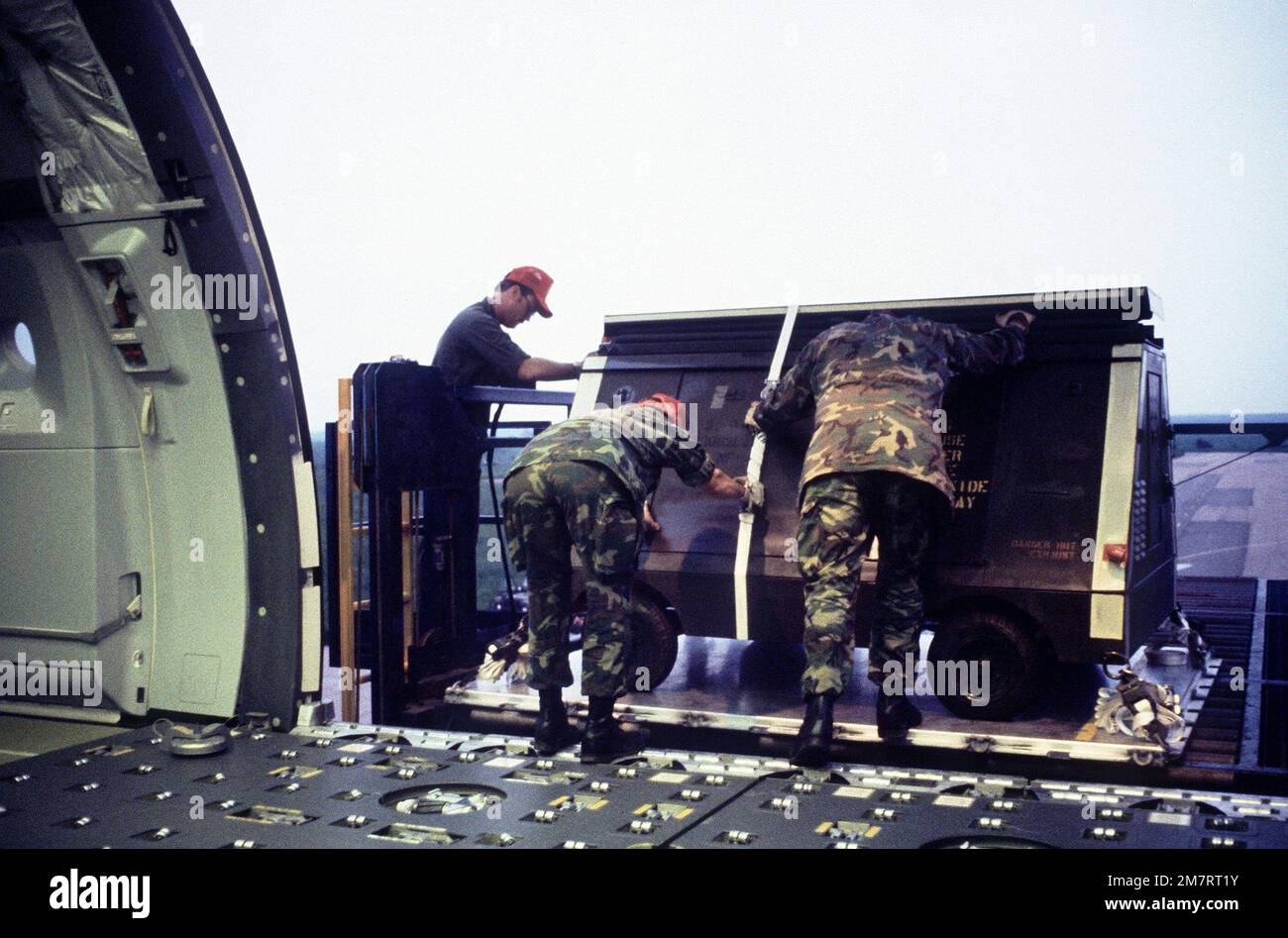 Interior view of a KC-10 Extender aircraft as cargo is positioned on a ...