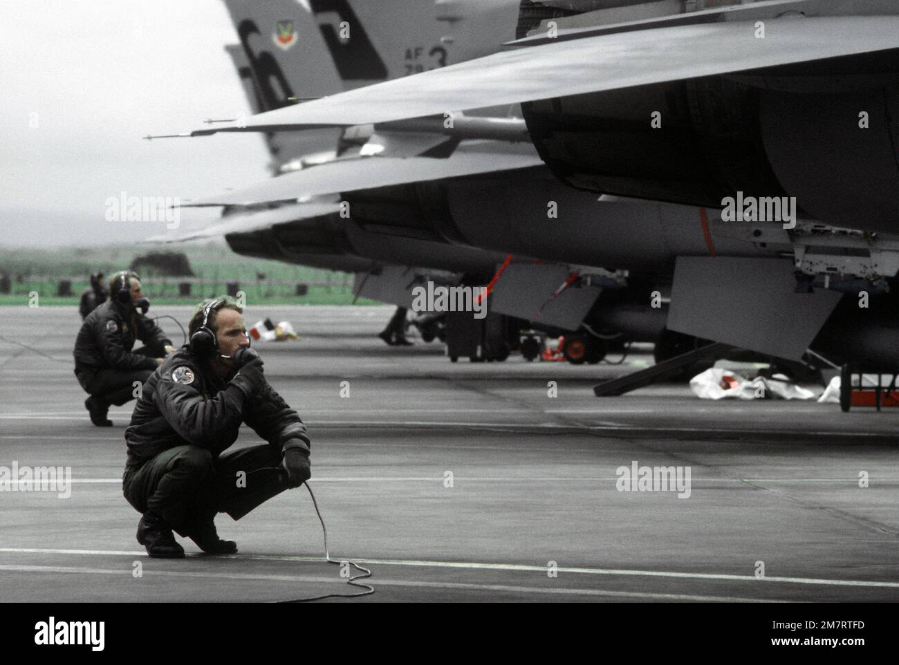 Ground crew chiefs radio to pilots of F-16A Fighting Falcon aircraft ...