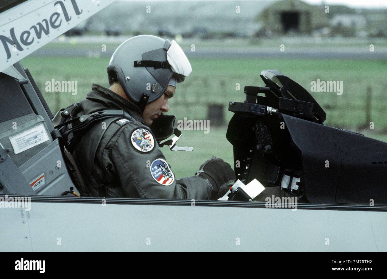 CPT Roger Riggs prepares for flight aboard an F-16A Fighting Falcon ...