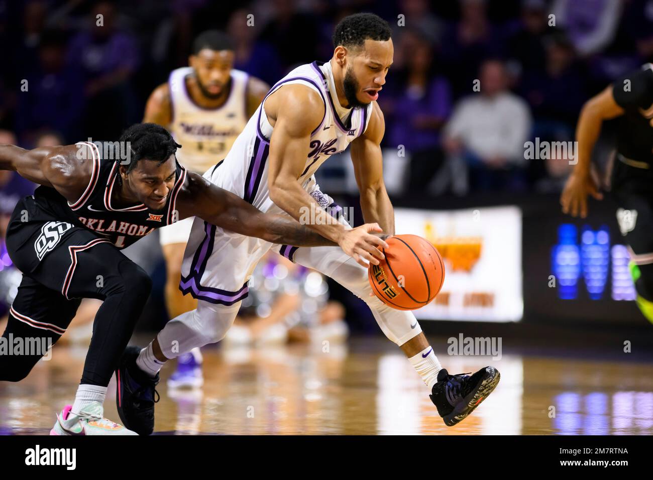 Oklahoma State guard John-Michael Wright (51) and Kansas State guard Markquis Nowell (1) chase a ...