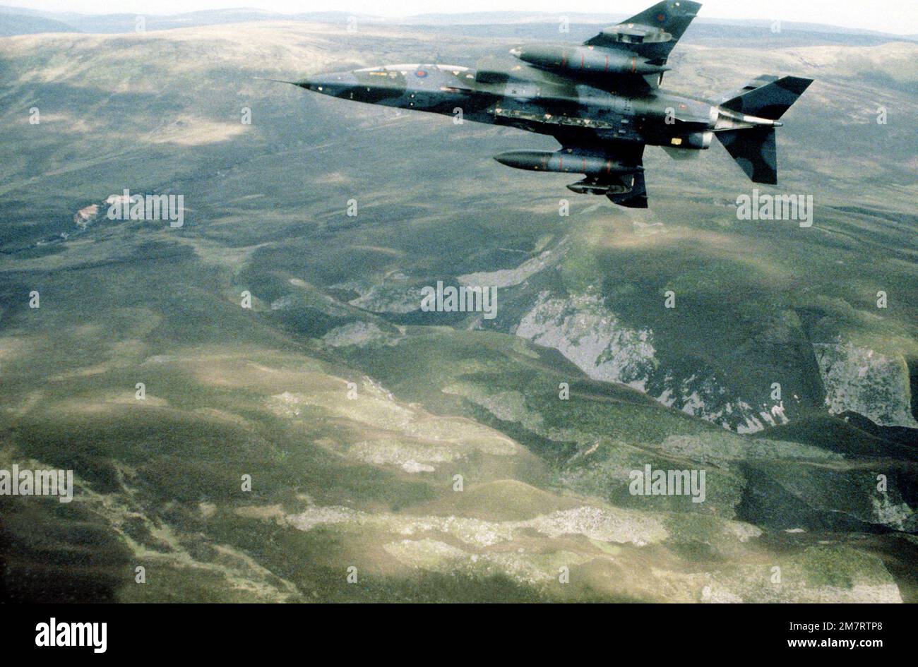 Bottom view of a Royal Air Force Jaguar aircraft in flight. The ...