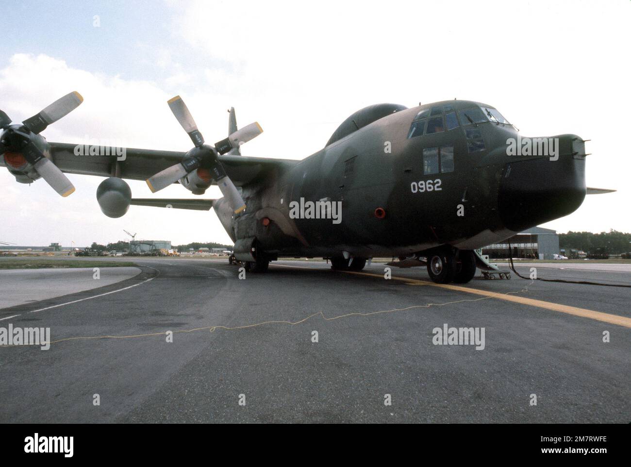 A low angle right front view of a C-130 Hercules aircraft on the ground ...