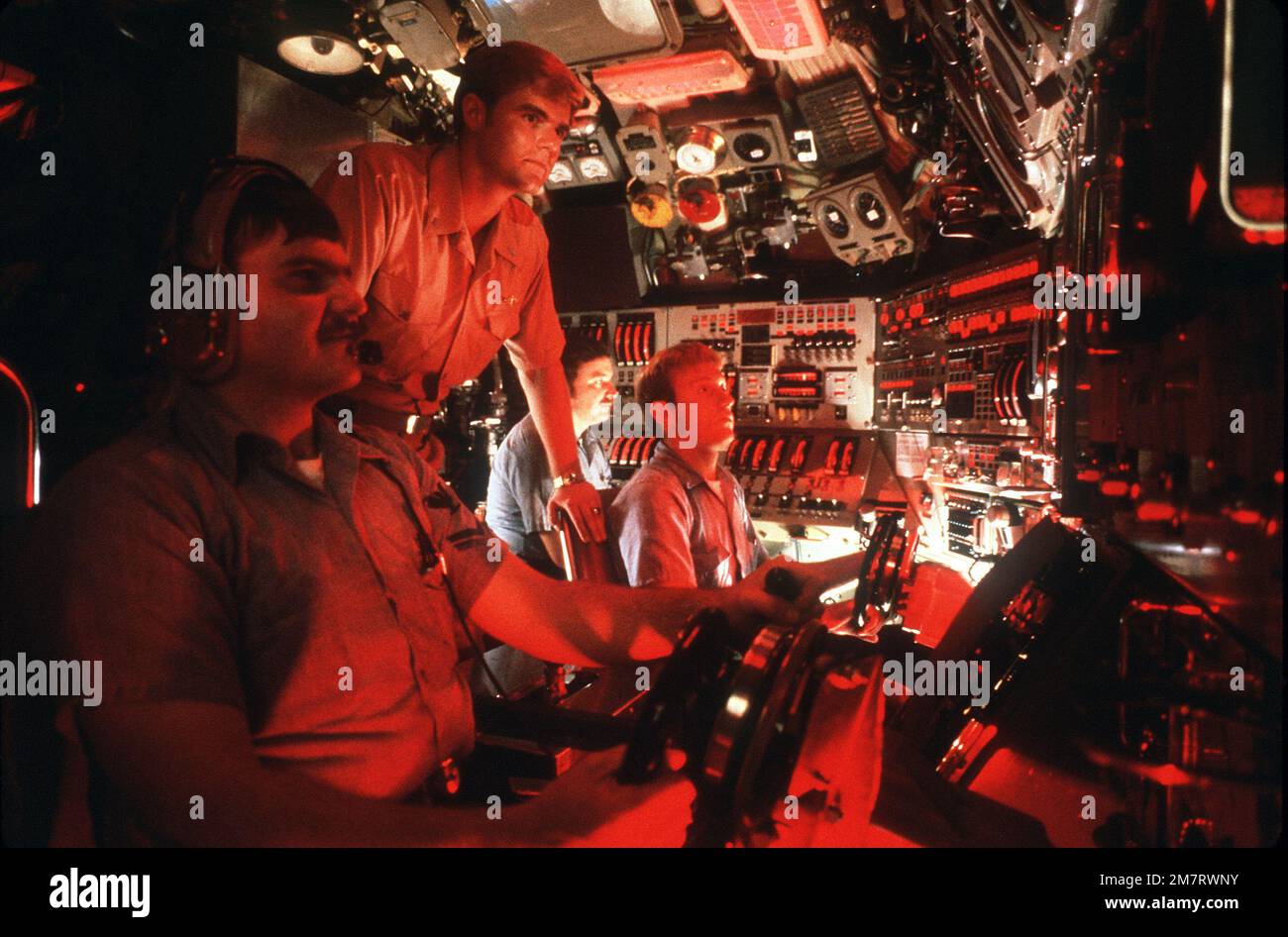 Crewmen monitor consoles at their diving stations aboard a Los Angeles ...