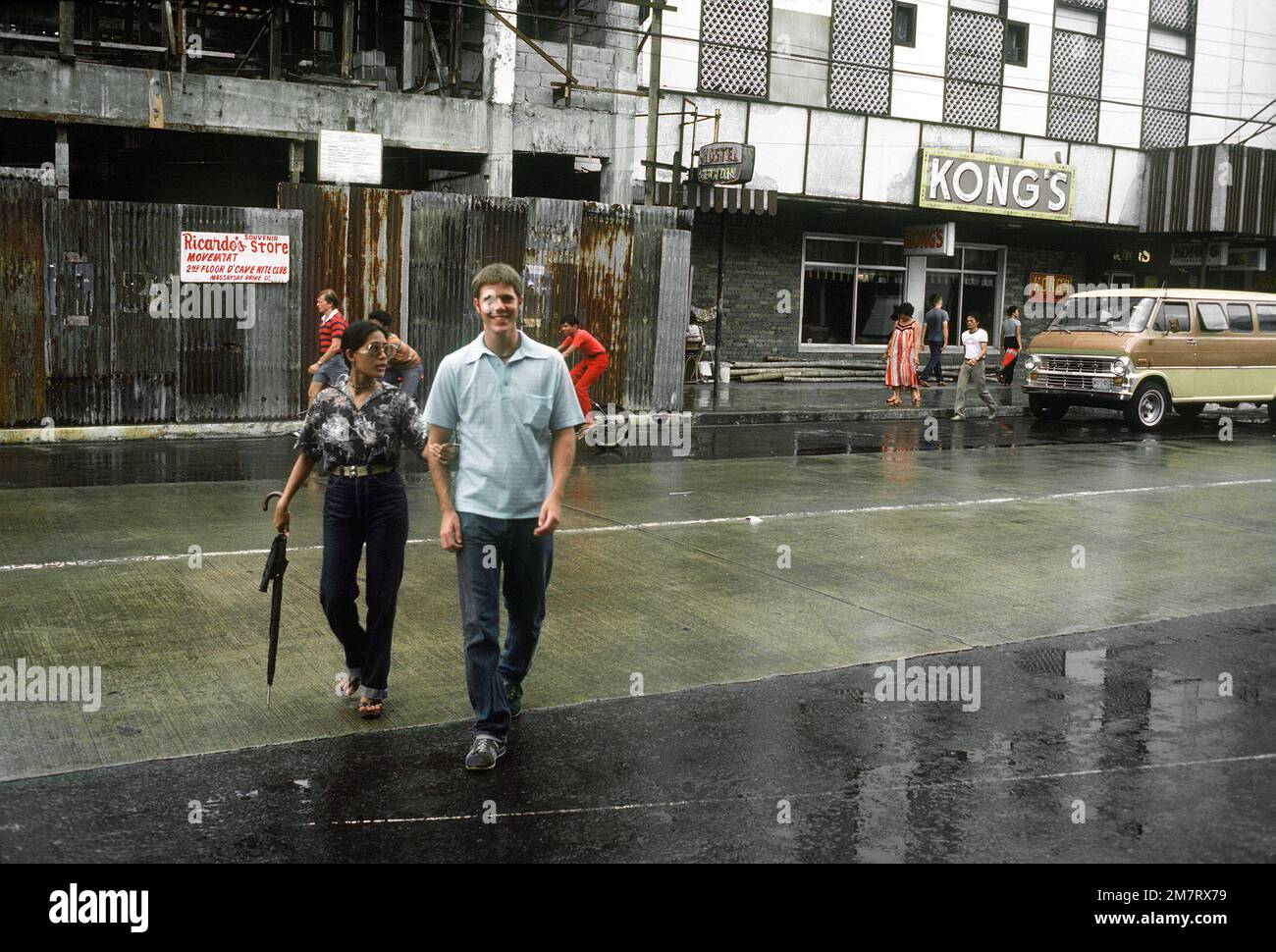 Pedestrians walk across a street. Base: Olongapo State: Luzon Country ...