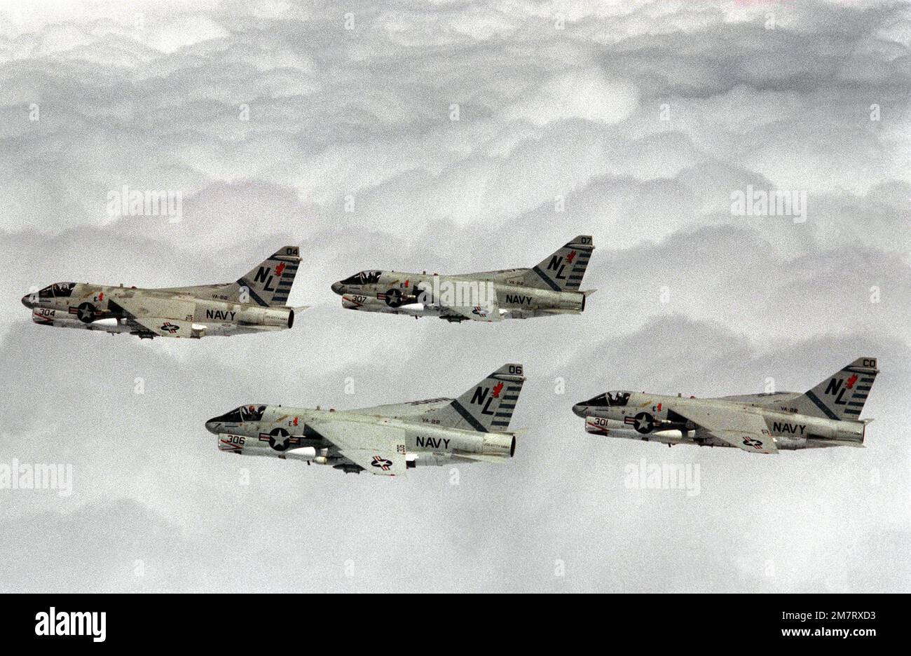 An in-flight left side view of four A-7 Corsair II aircraft from Attack ...