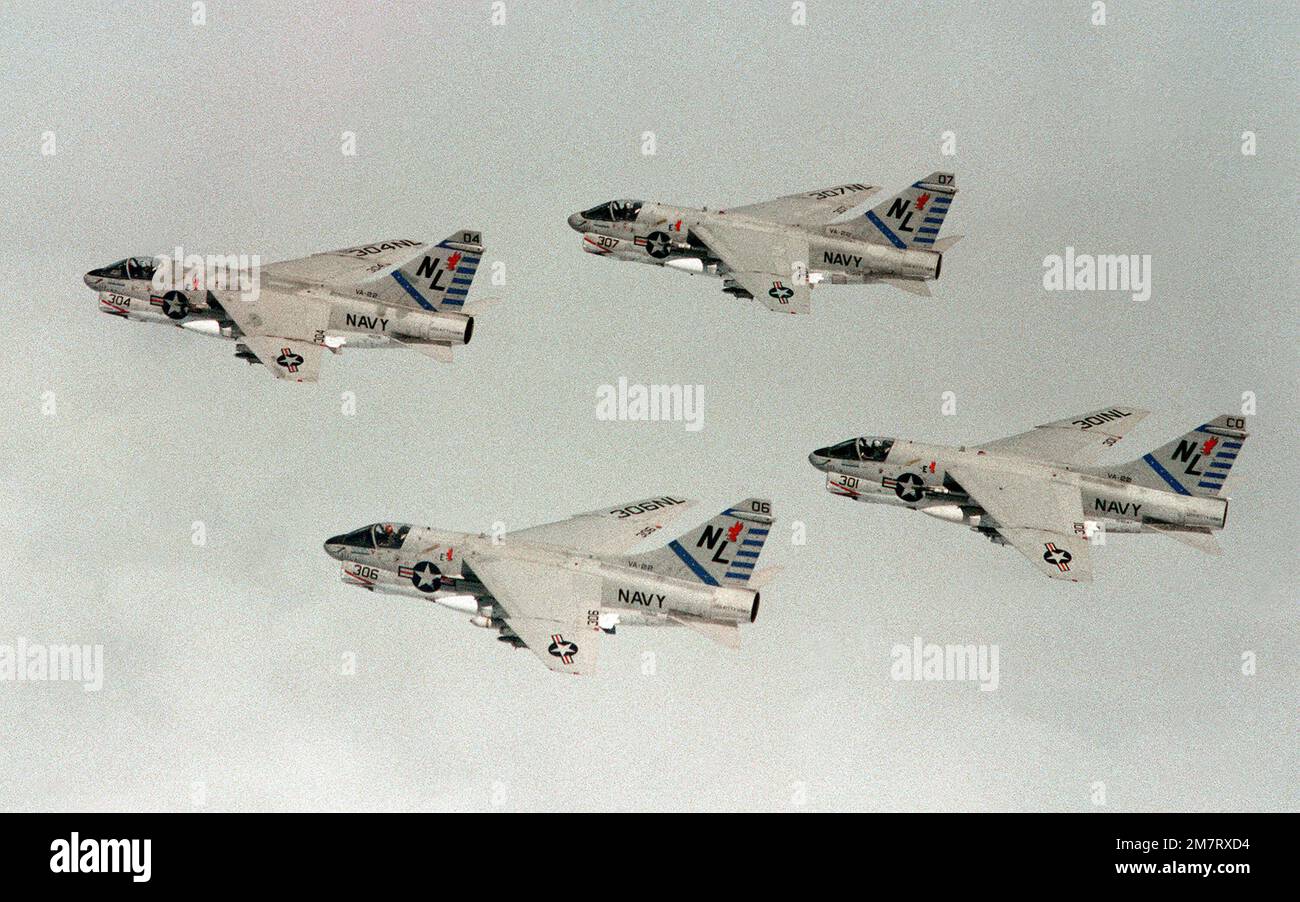 An air-to-air left side view of four A-7 Corsair II aircraft from ...
