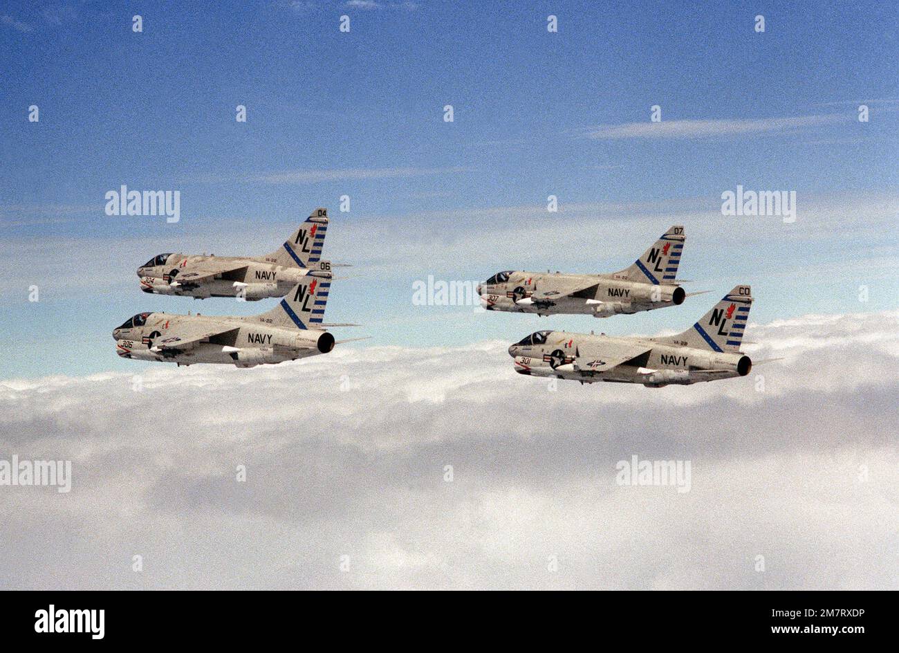 An air-to-air left rear view of four A-7 Corsair II aircraft from ...