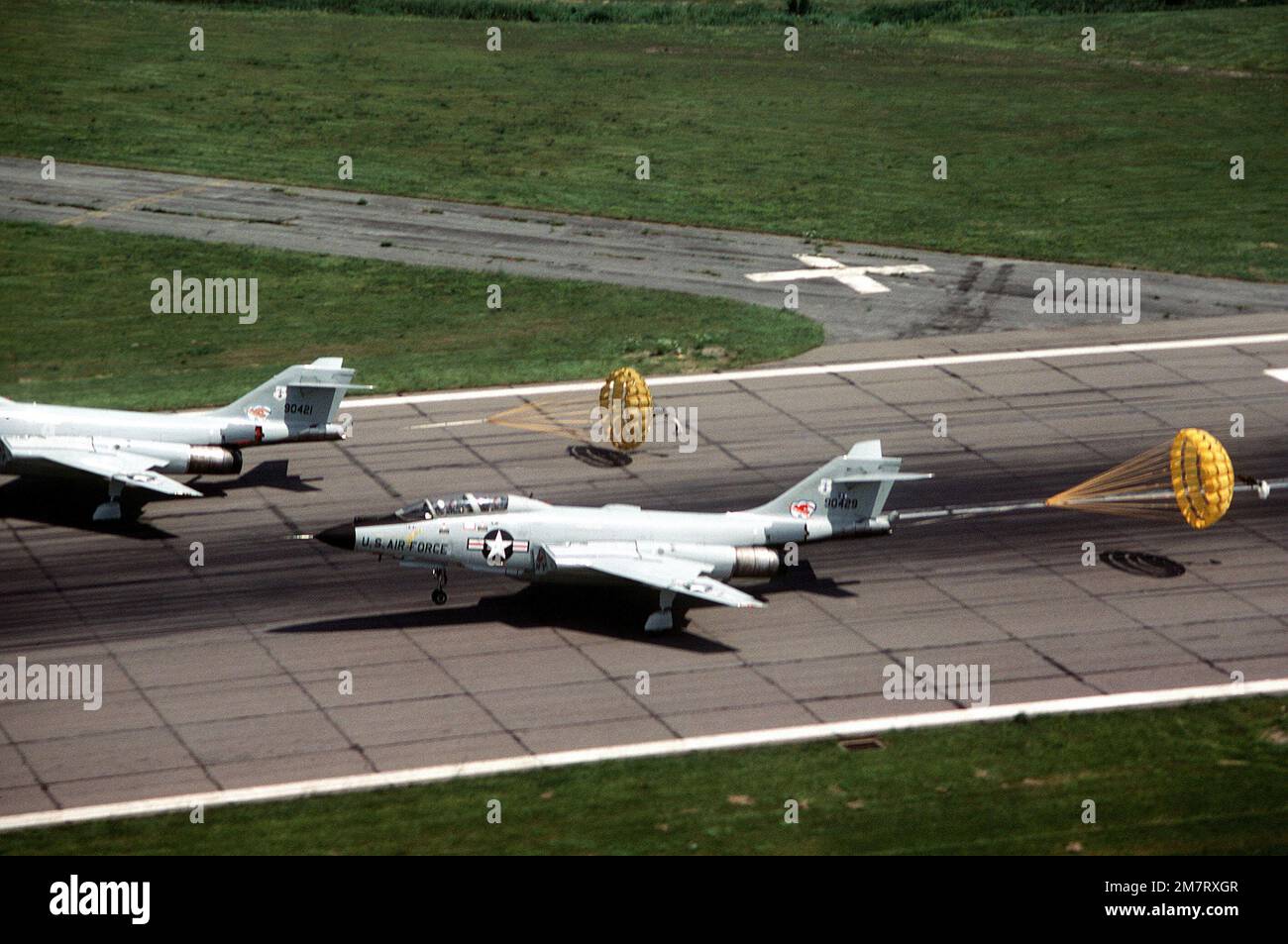 A left side view of the two F-101 Voodoo aircraft landing, with their ...