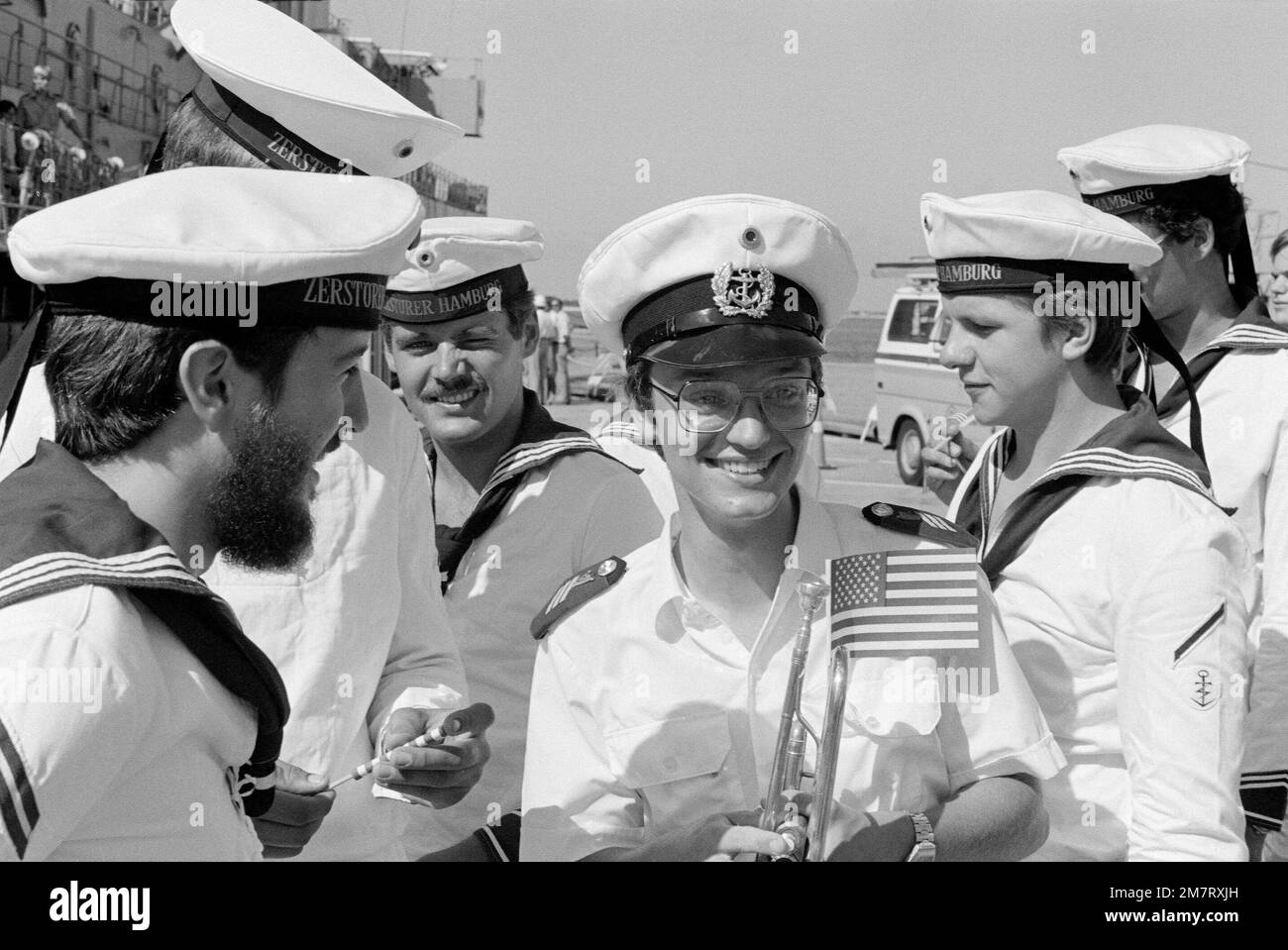 Crewmen from the West German destroyer HAMBURG (D-181) are given ...
