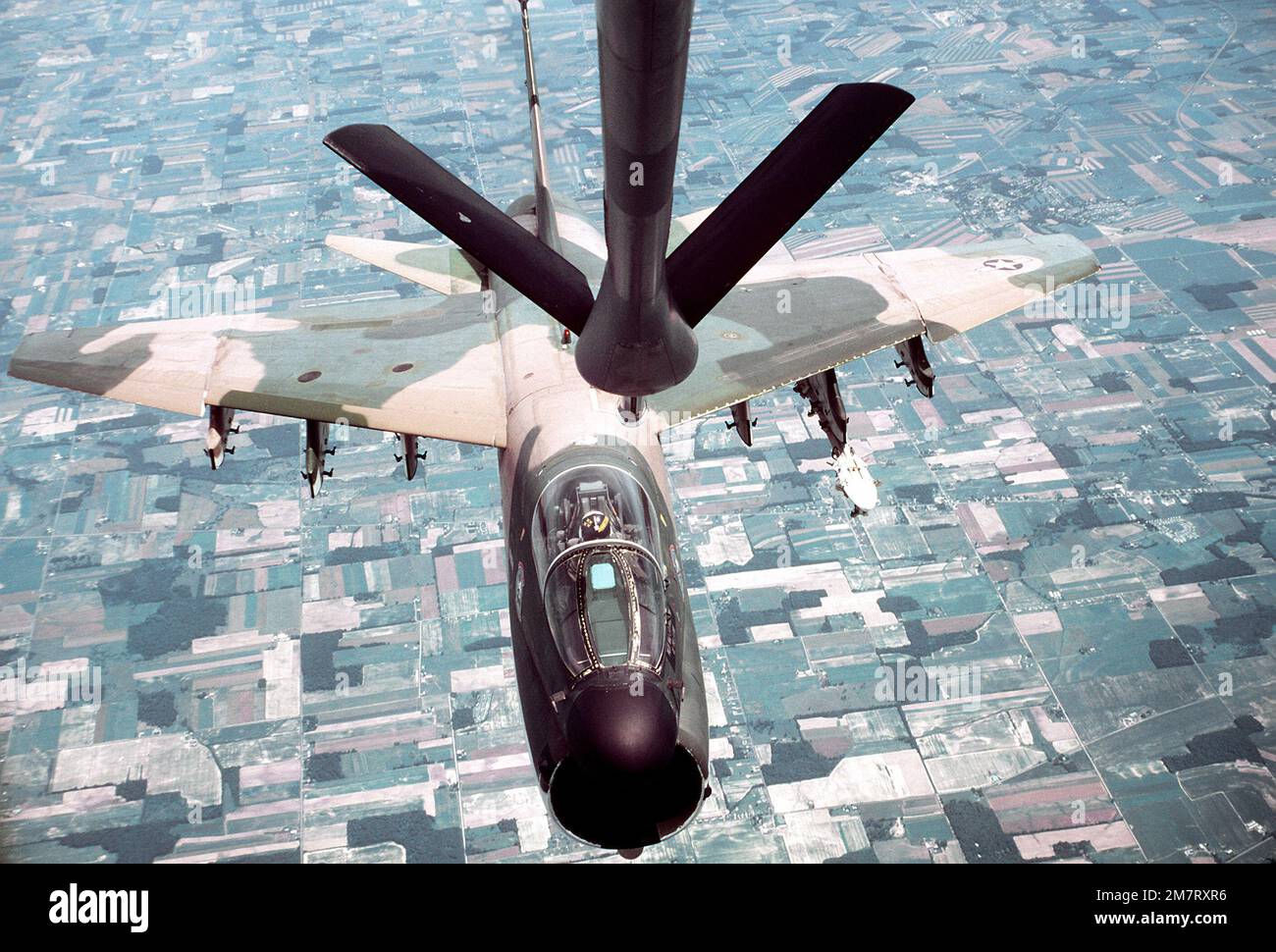 AN air-to-air front view of an A-7 Corsair II aircraft heading toward a KC-135 Stratotanker ...