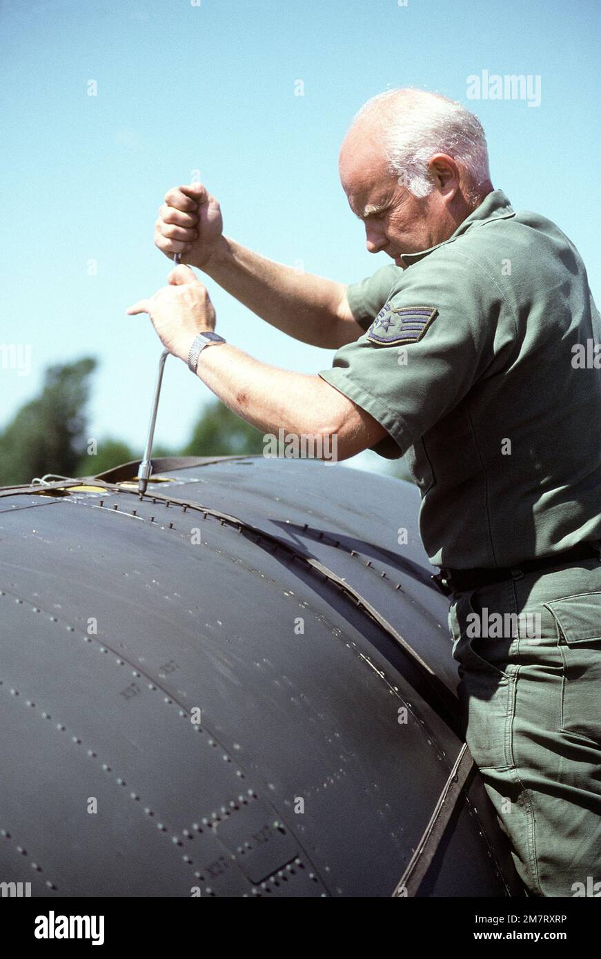 SSGT Floyd H. Godfrey unscrews an A-10 Thunderbolt II aircraft engine ...
