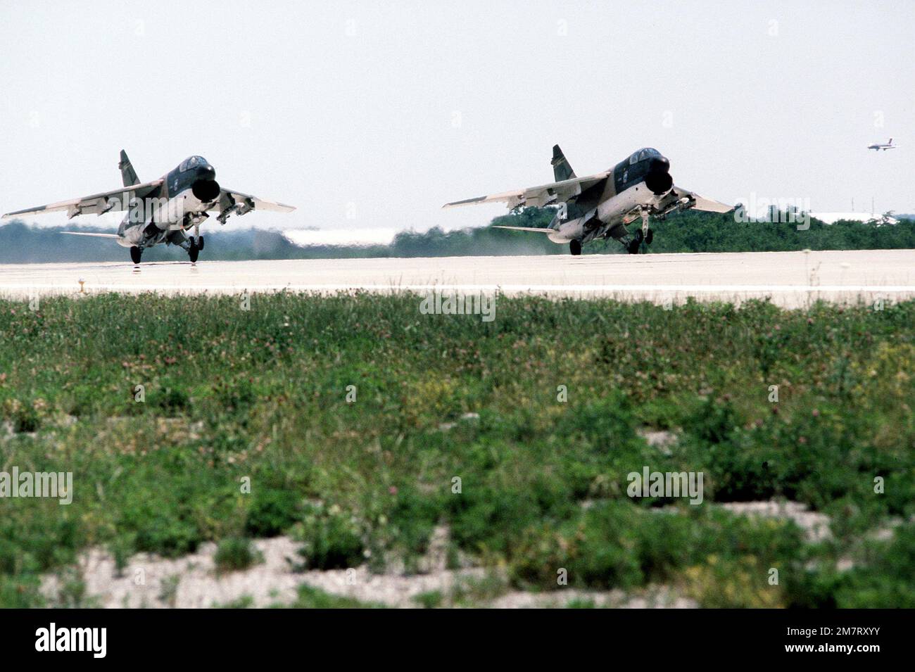 A right front view of two A-7 Corsair II aircraft taking off during ...