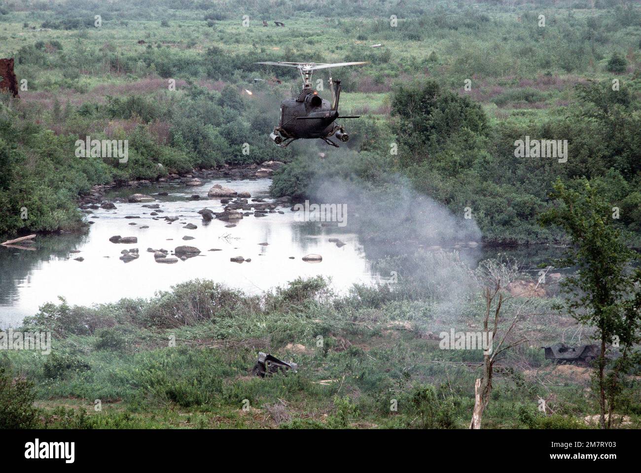 AN air-to-air view of an AH-1 Cobra helicopter firing a missile during ...