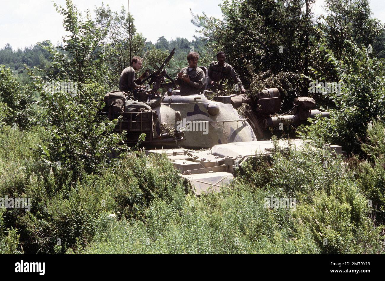 Soldiers, aboard an M-60 aggressor forces tank, enjoy their lunch break ...