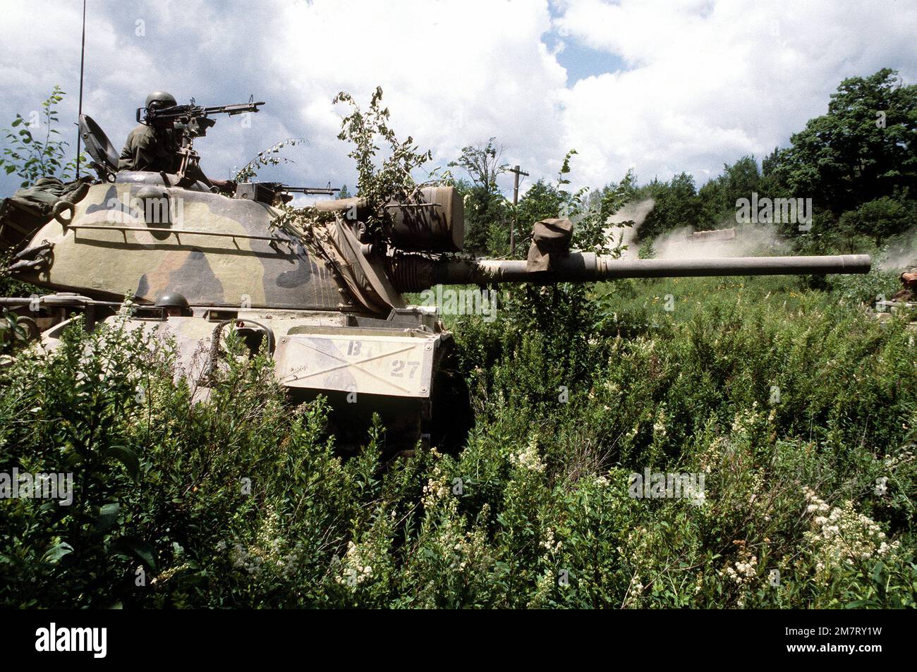 AN M-60 aggressor forces tank group maneuvers through the field during ...