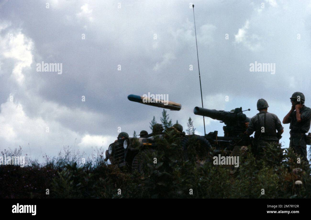 Military personnel fire a tube-launched, optically-tracked, wire-guided ...