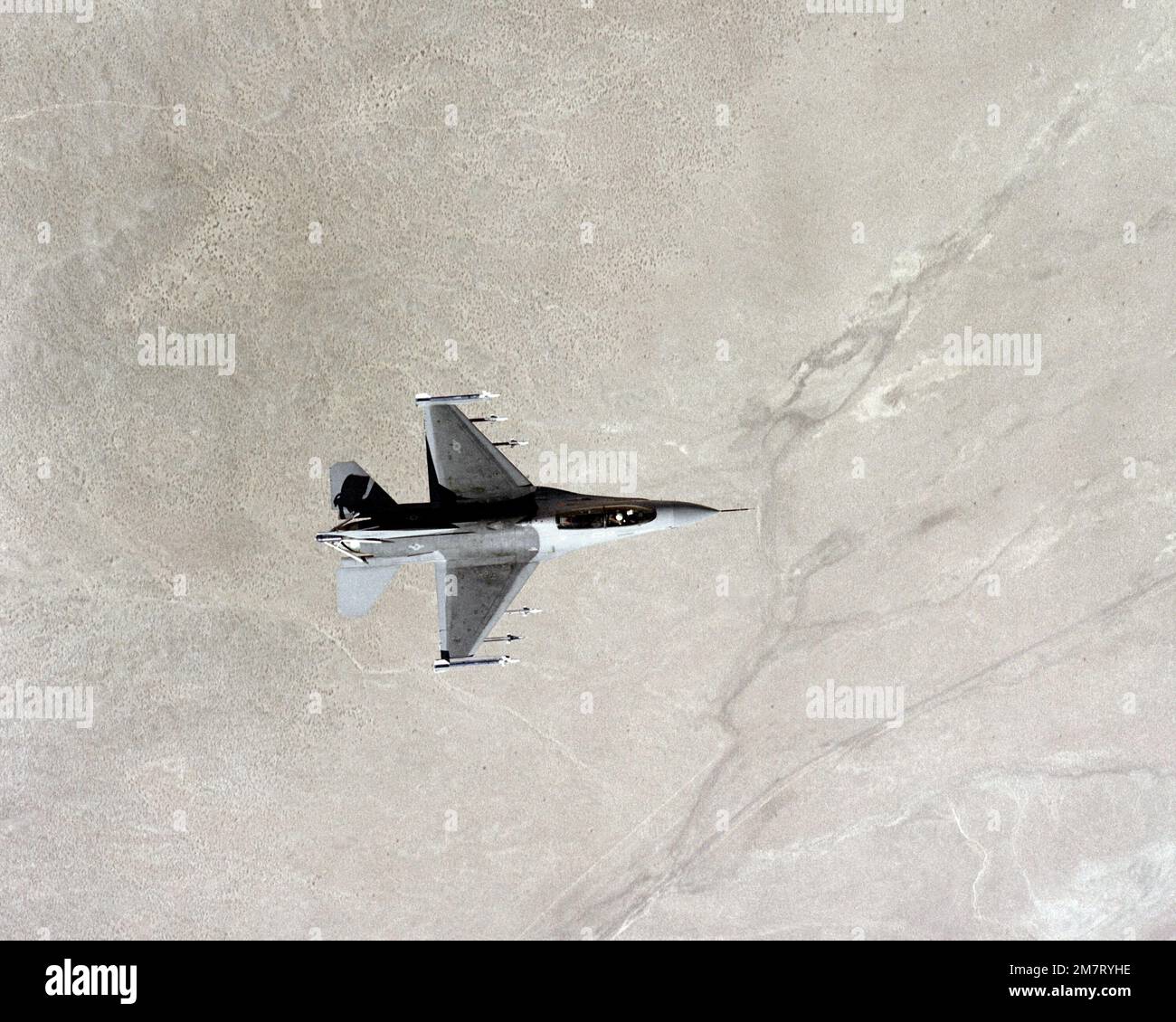 An air-to-air overhead view of an F-16B Fighting Falcon aircraft with ...