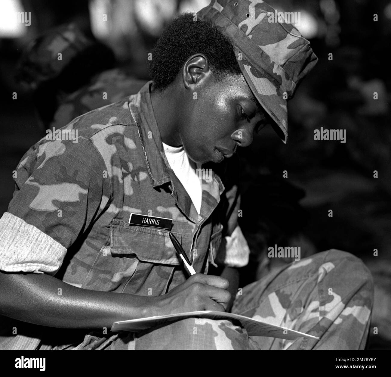 PVT L. H. Harris of Series 9a takes a written examination on clothing ...