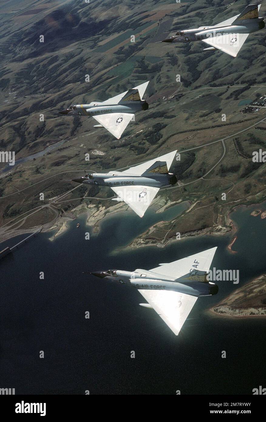 An air-to-air left side view of four-ship wedge formation of F-106 ...