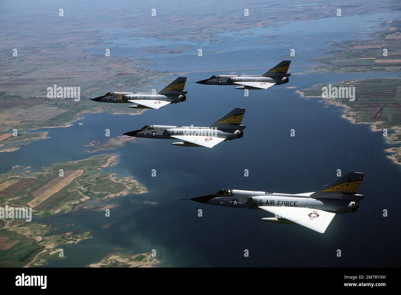 AN air-to-air left side view of a four-ship wedge formation of F-106 ...