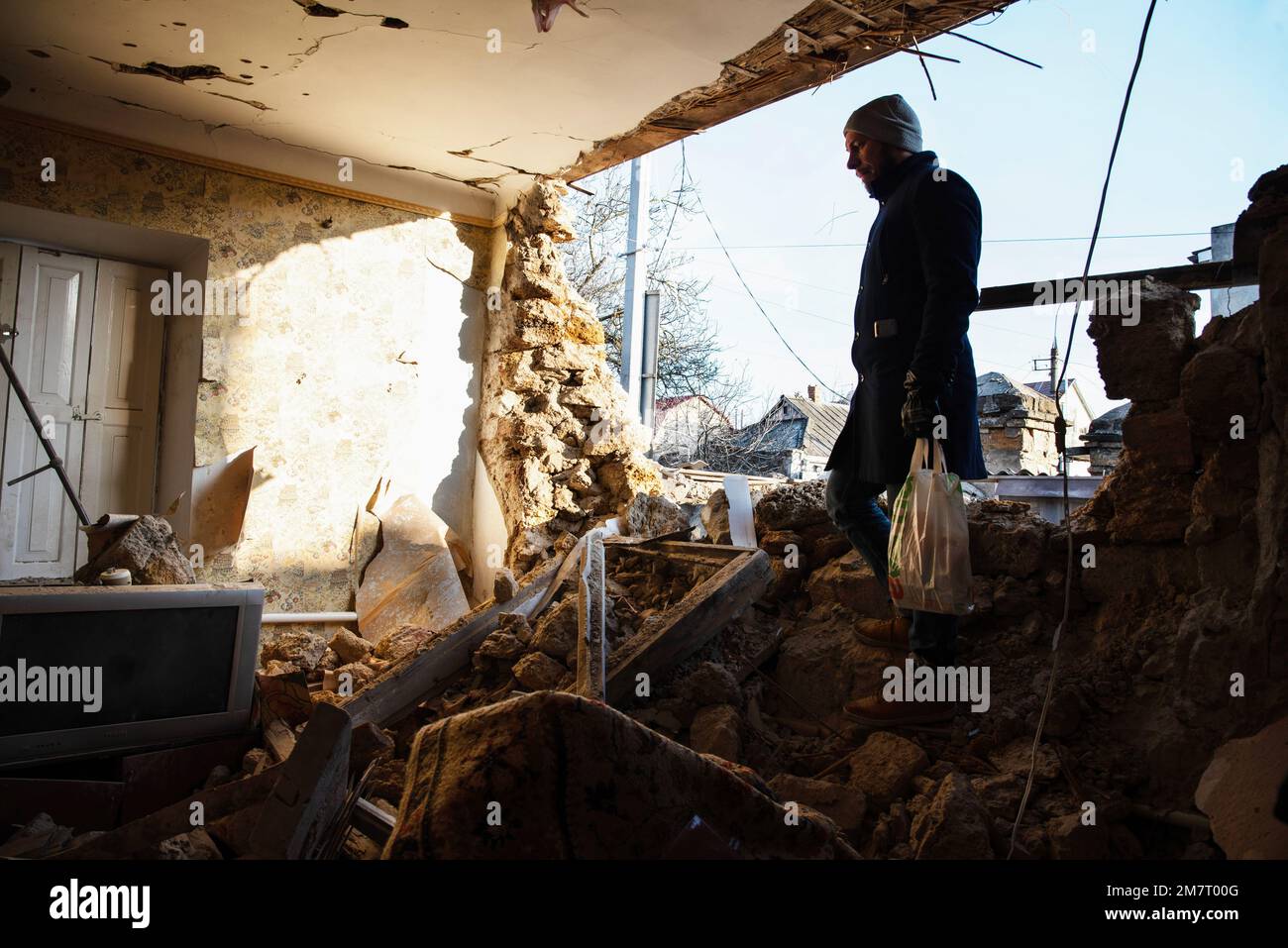 Kherson, Ukraine. 10th Jan, 2023. A man walks on the rubble of a ...