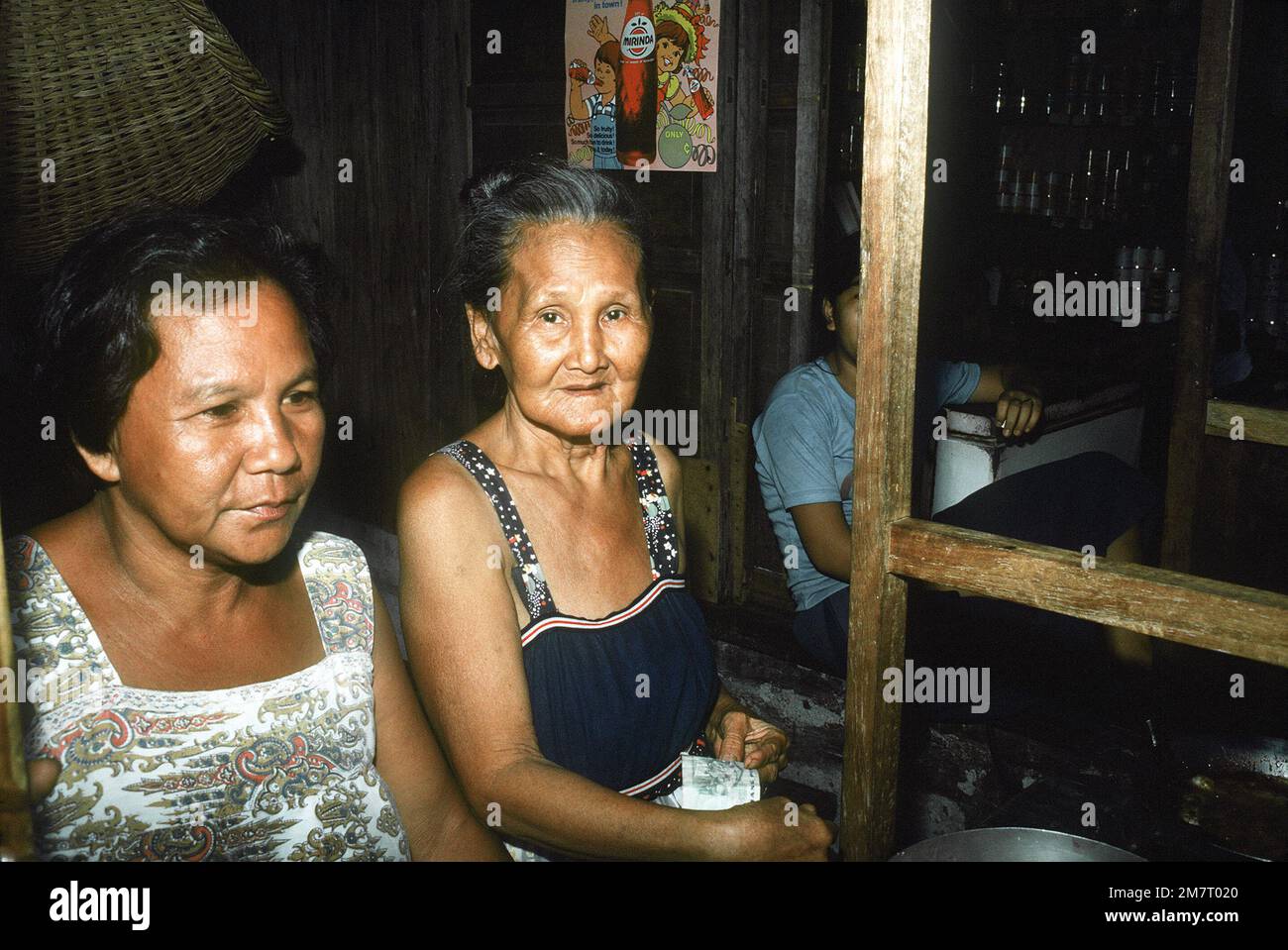 Two Filipino women sit together. Base: Olongapo State: Luzon Country ...