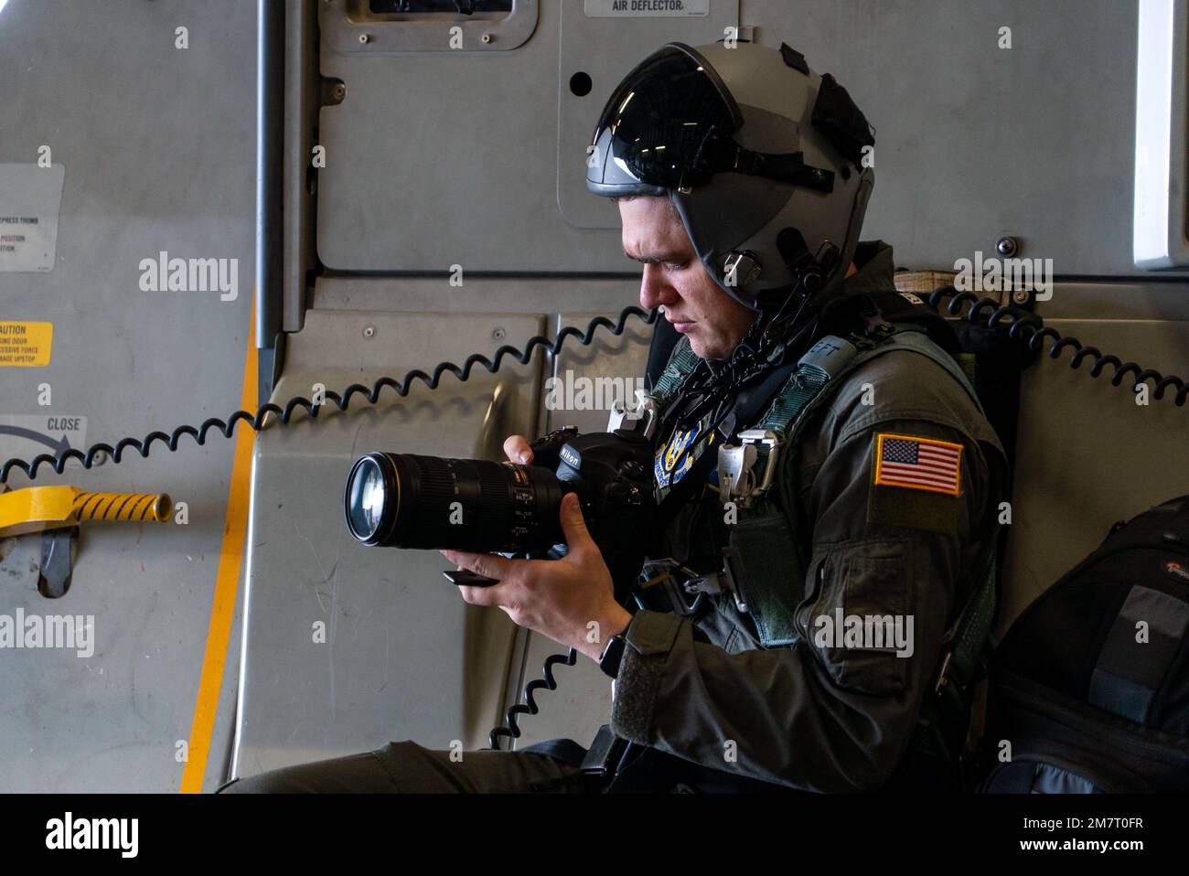 Senior Airman Caleb Roland, 4th Combat Camera aerial combat photojournalist takes photos of an ...