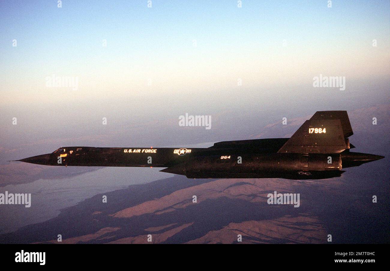 An air-to-air left side view of an SR-71 Blackbird aircraft from the ...