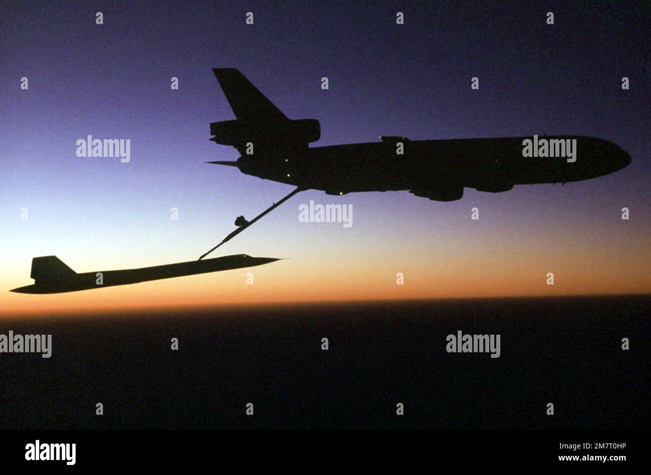 Right side view of a KC-10 Extender aircraft refueling an SR-71 ...