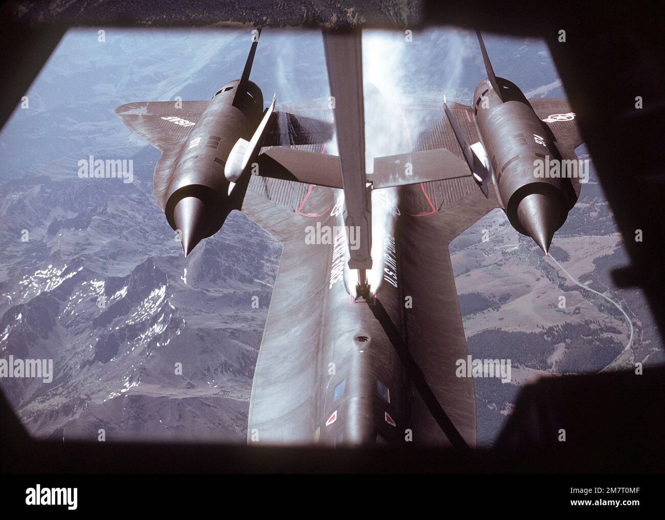 An air-to-air front view of an SR-71 Blackbird aircraft being hooked up ...