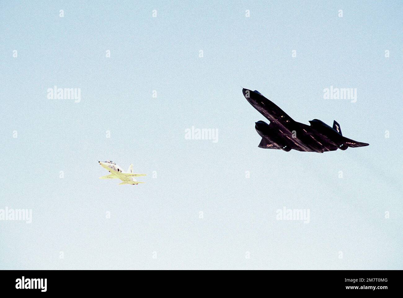 A view of an SR-71 Blackbird aircraft, flanked by a T-38 Talon aircraft ...