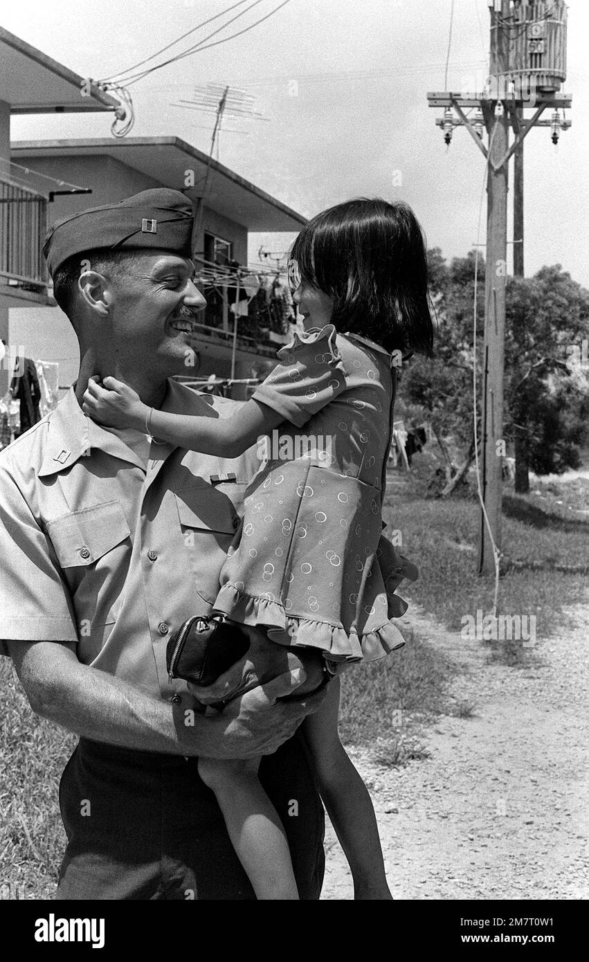 Navy Chaplain (LT.) Chris E. Fosback holds a Vietnamese child during ...