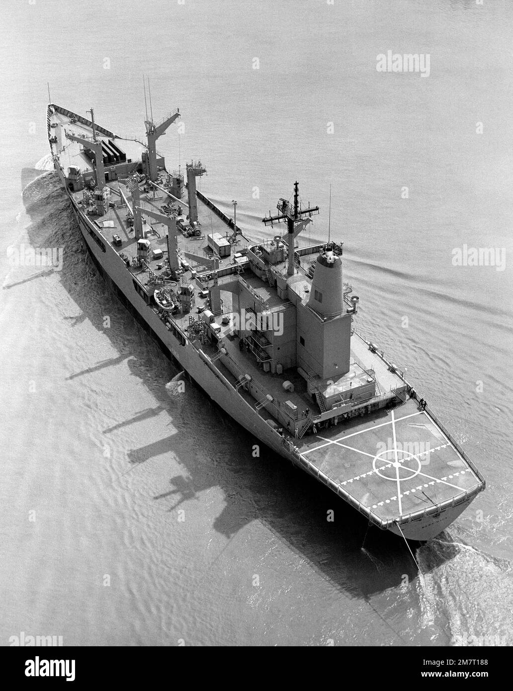 Aerial port quarter view of the oiler USS MERRIMACK (AO 179) underway ...
