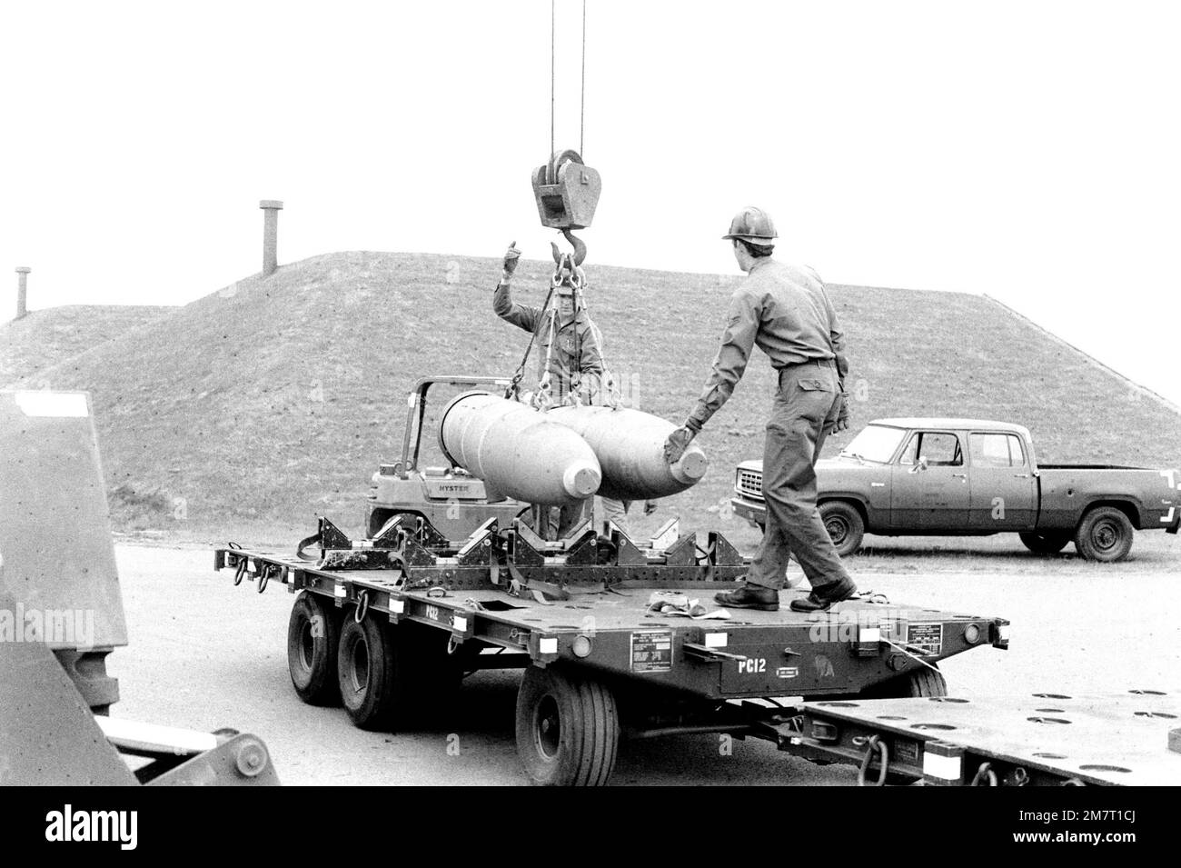 A1C Mark L. Sayke and Thomas A. Driskell load laser-guided bombs on a ...