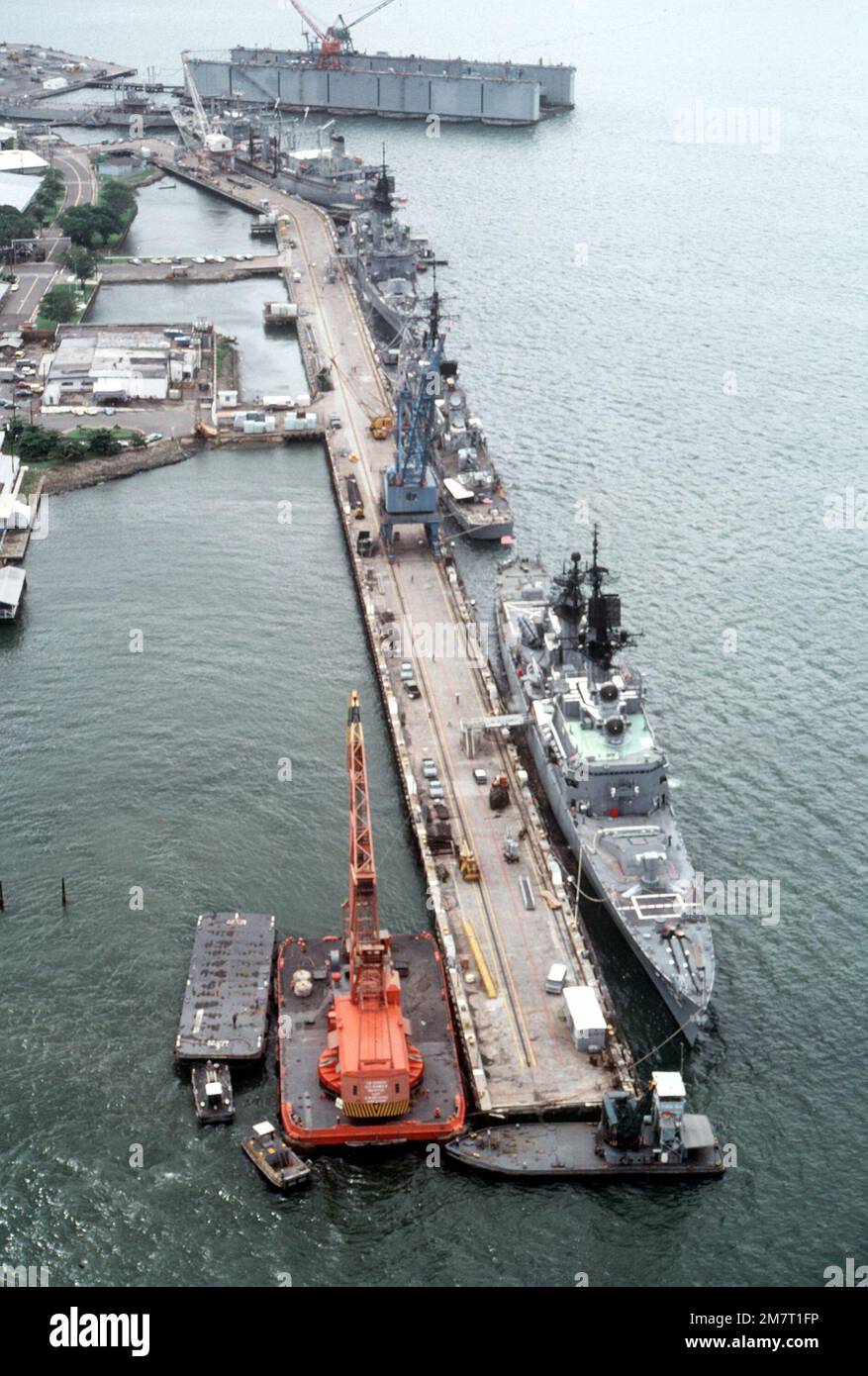 A high angle view of a floating dry dock and ships docked at the pier ...