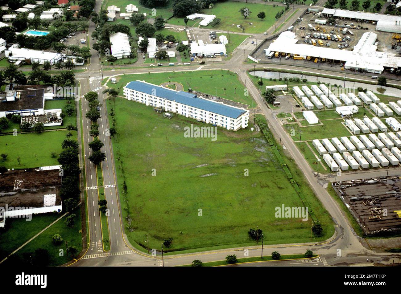 An aerial view of buildings and a trailer park at the right. Base ...